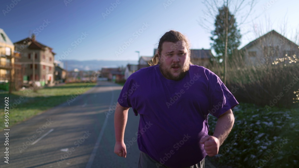 One overweight man starts to run outside getting back to into shape ...