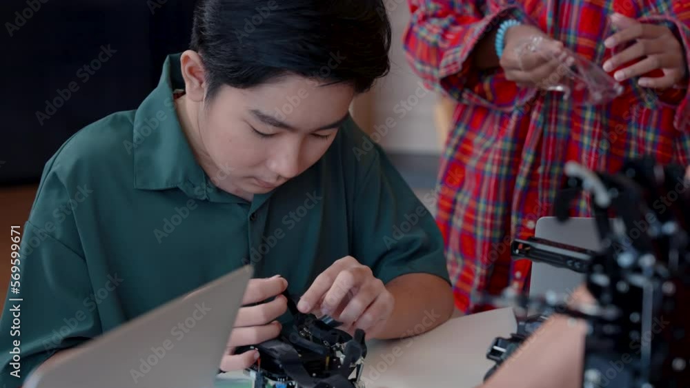 4K, student is trying put his finger in finger loop robotic hand, that ...