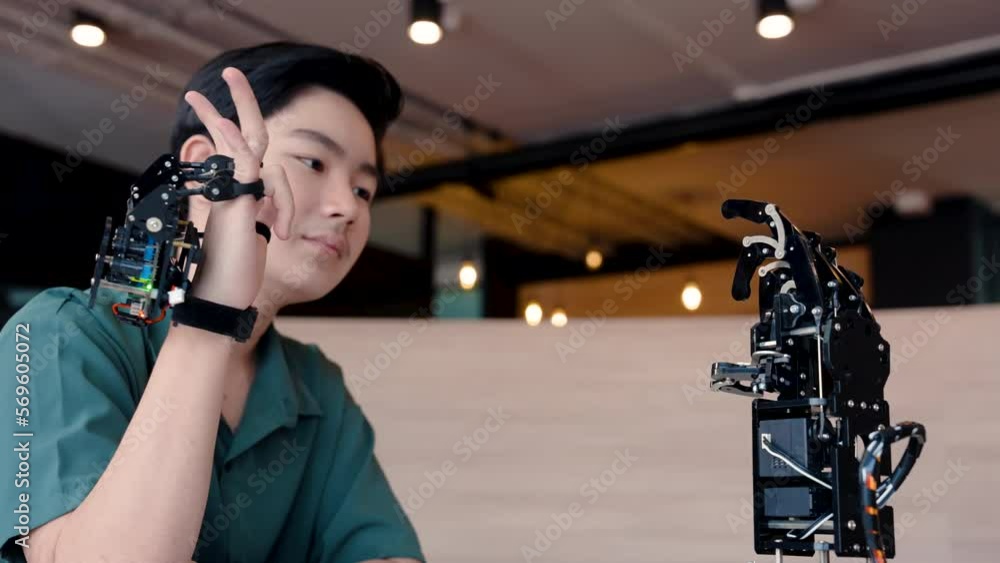 4K, Male student in technology class Wearing hand robotic controller is ...