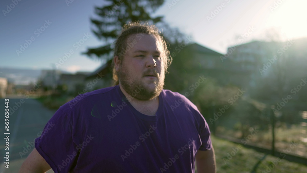 One pensive young overweight man walking outdoors. Thoughtful ...