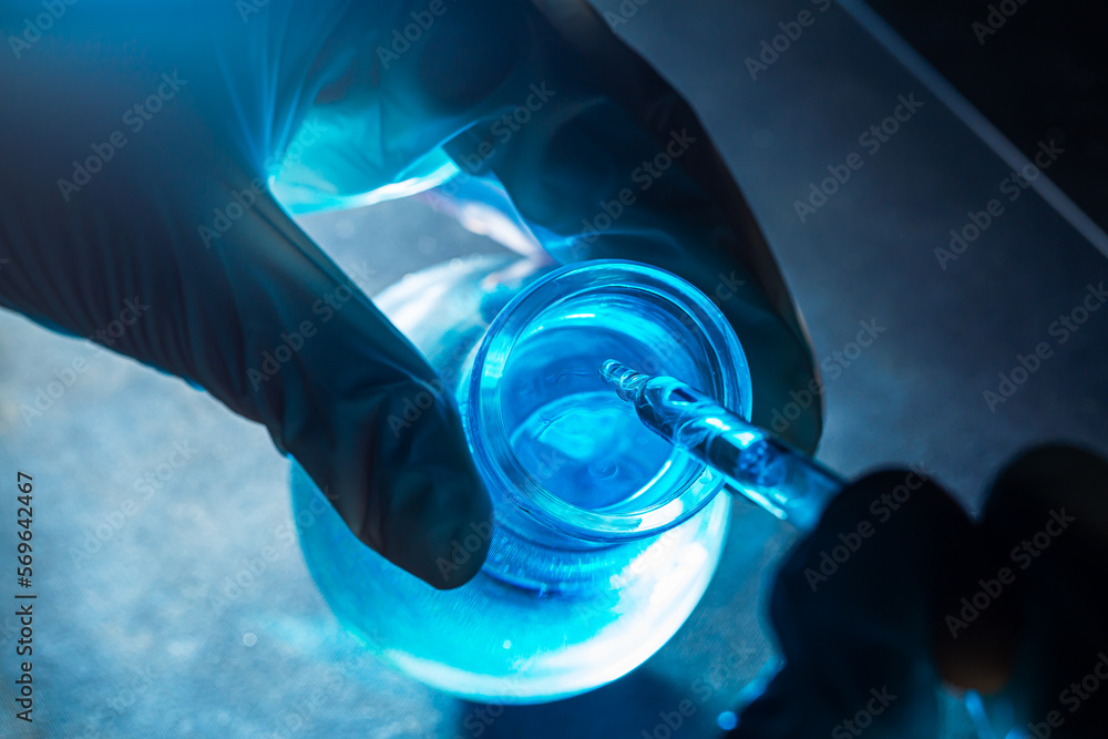 Blue science experiment glass tube,Researchers with chemistry test ...