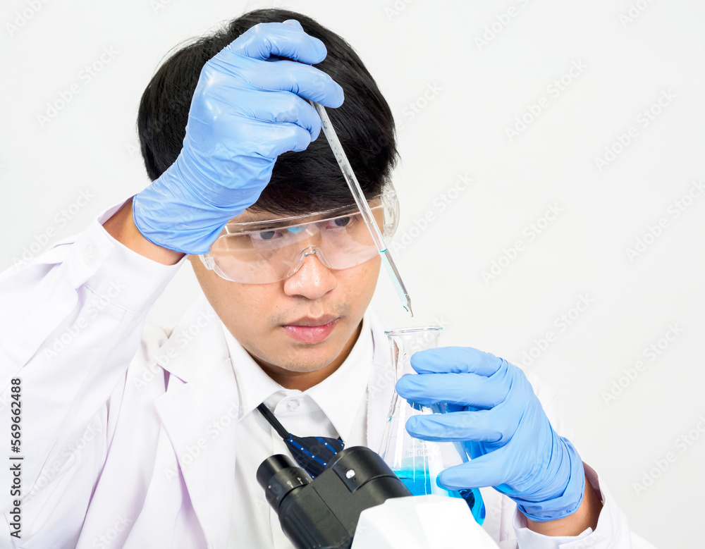 Asian man student scientist or doctor look hand holding in reagent mixing laboratory In a ...