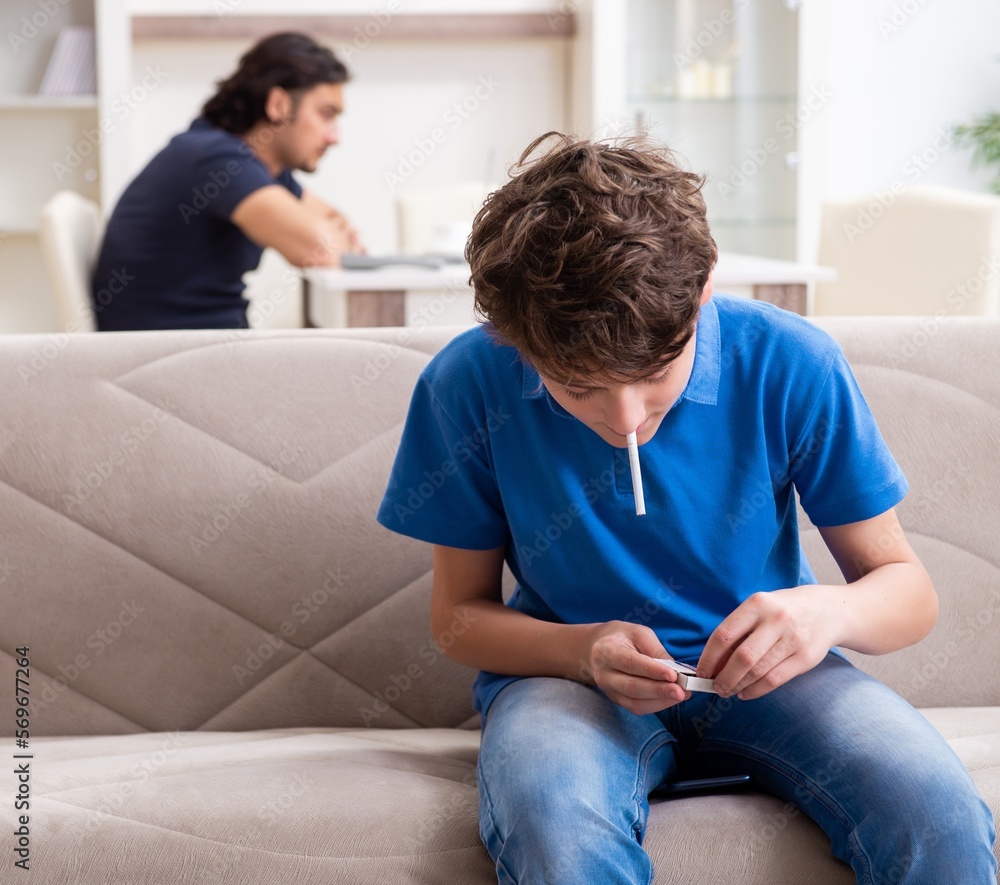 Concept of underage smoking with young boy and family Stock Photo ...