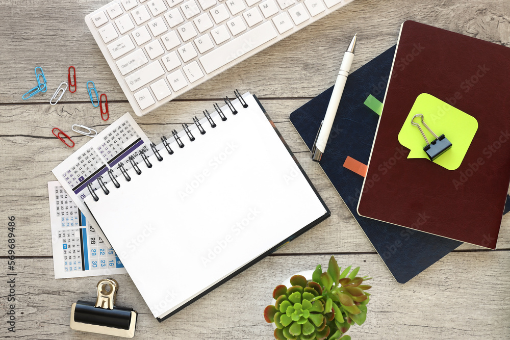 Top view of white wooden office table with computer and office supplies ...