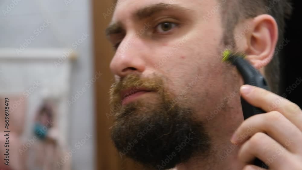 The process of shaving the beard close-up. A man shaves his beard close ...