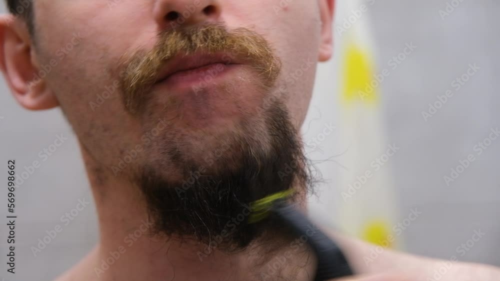 Young guy shaves his beard at home. Personal care. A man shaves his ... Young guy shaves his beard at home. Personal care. A man shaves his ...