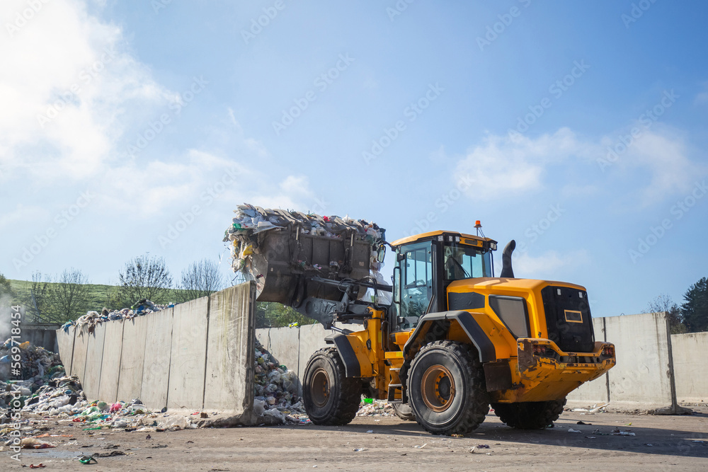 Front loader with scrap handling grapple bucket moving forward and ...
