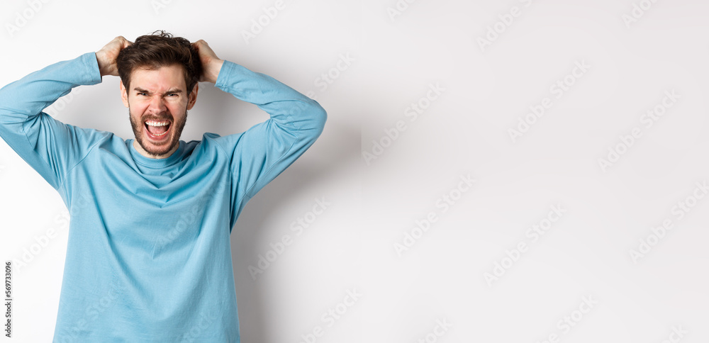 Mad young man pull hair oyt of head and screaming angry, shouting ...