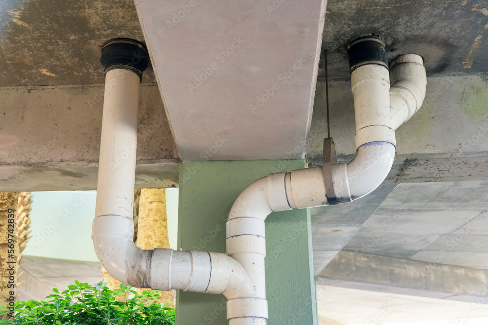 White pvc drain pipes below the parking garage building in Destin ...