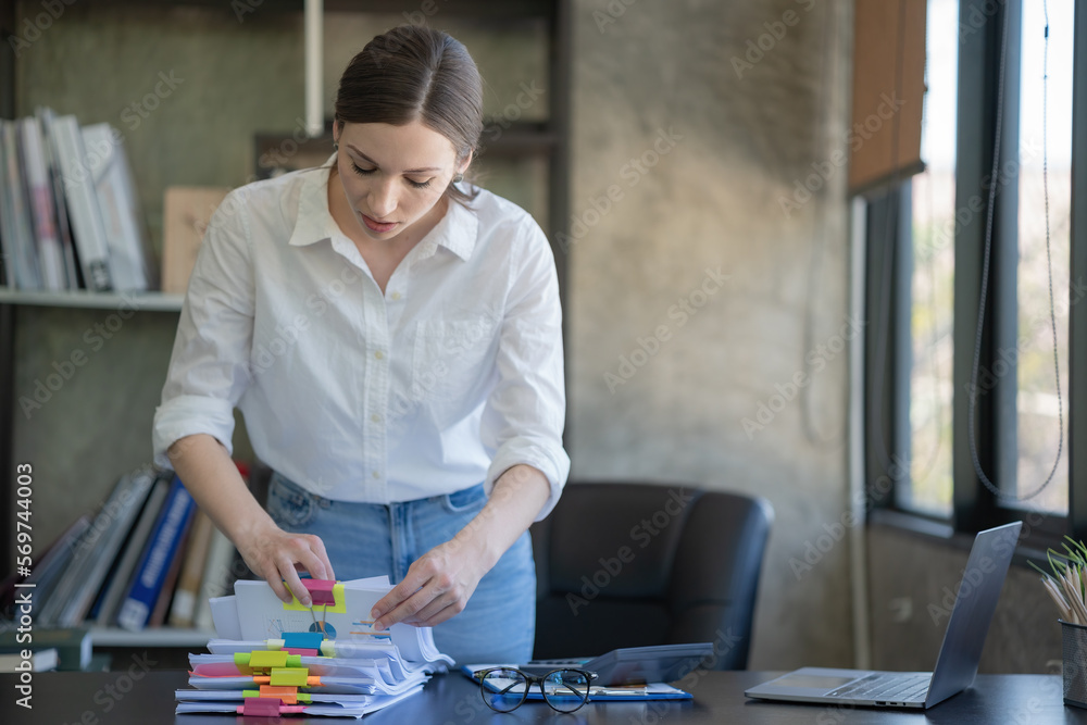Businesswoman hands working in Stacks of paper files for searching and ...