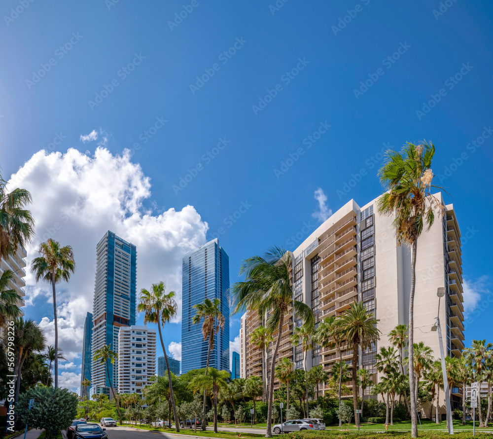 Street view of modern high-rise buildings against the giant clouds and ...