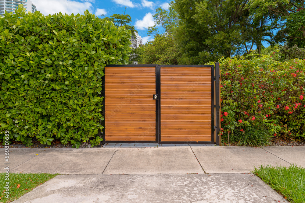Home entrance driveway gate with wood slats in Miami, Florida. Gate of ...