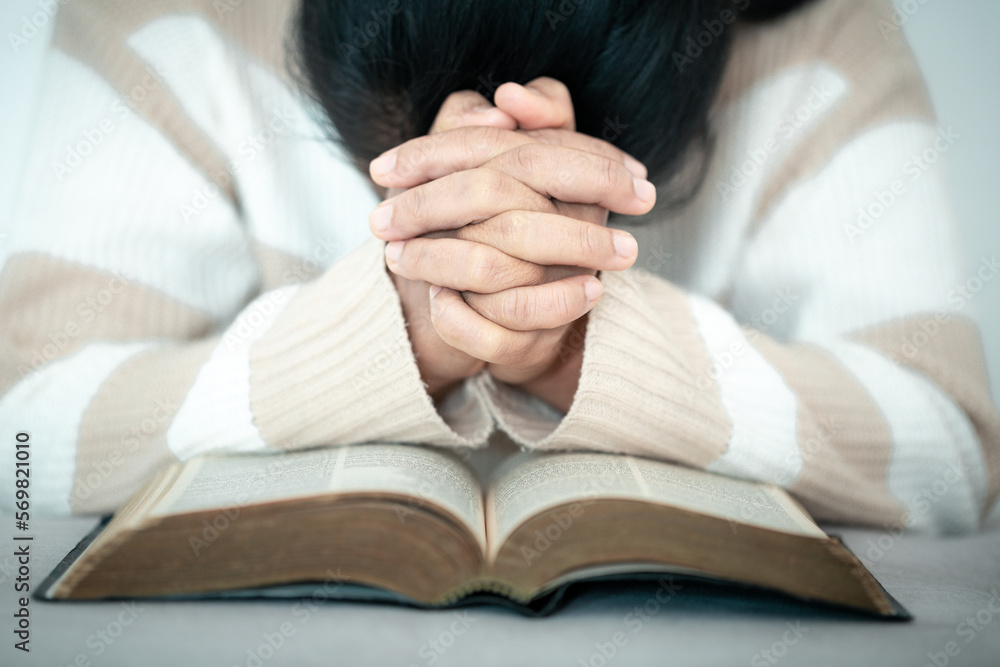 woman kneeling and praying in modern house at sunset time. Female ...