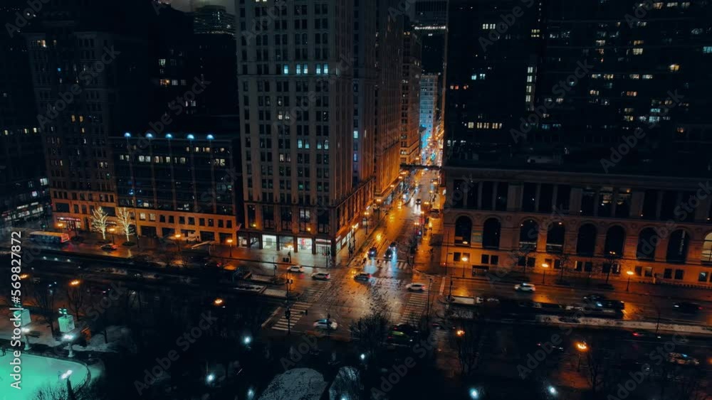 parallax aerial of chicago street at night in the winter 2023 with a ...