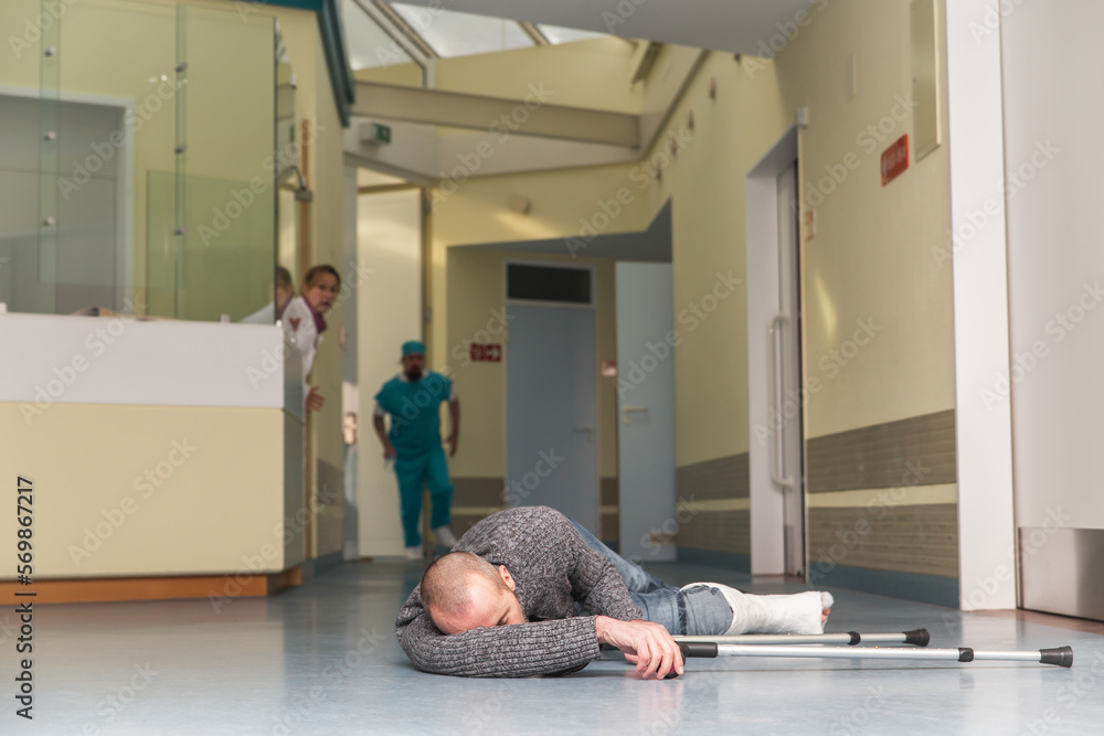 emergency at the corridor of the hospital, patient lying on the floor ...