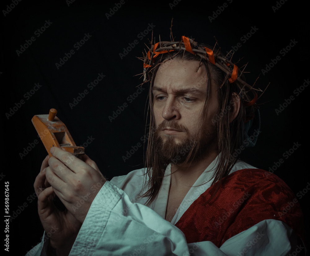 Jesus Christ with plane saw wearing a crown of thorns and white chiton ...