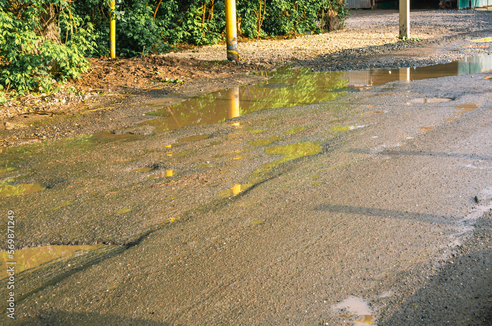 Broken roadbed. There are damages on the asphalt, which got rainwater ...