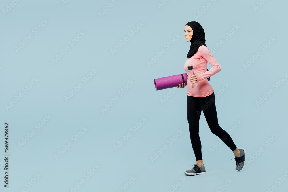 Full body young muslim fitness trainer sporty woman wear pink abaya ...