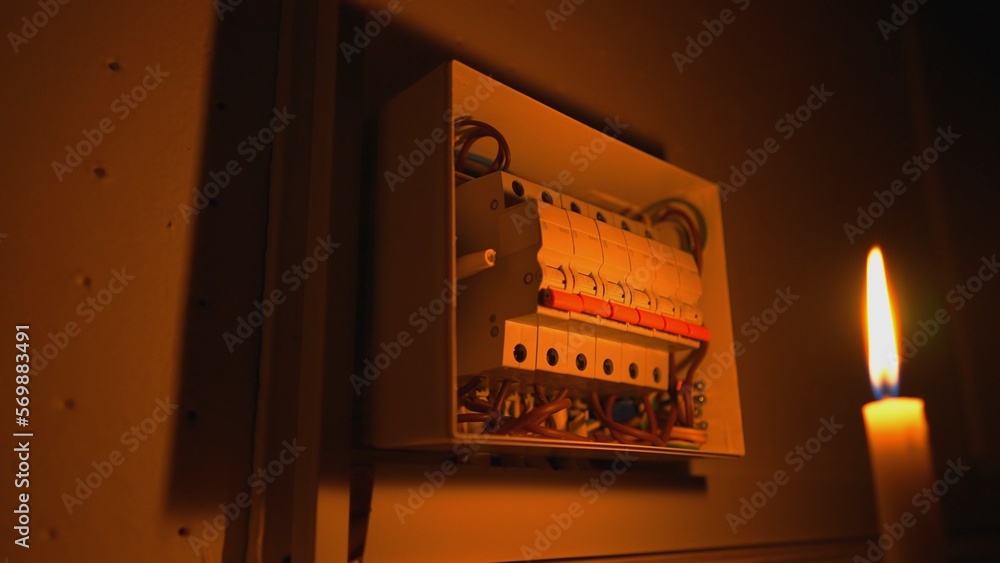 High voltage automatic breaker switch, close up in the dark. Candle ...