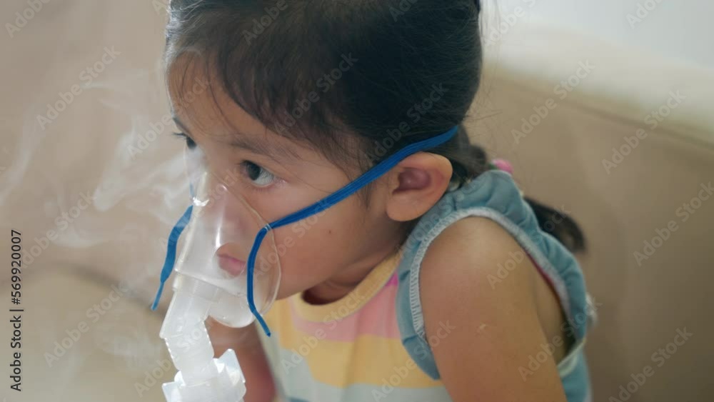 Kid girl making makes inhalation nebulizer steam sick cough at home ...