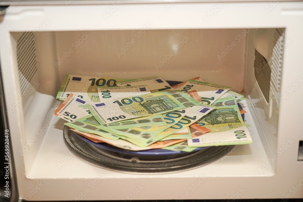 Banknotes 50 and 100 euros in the microwave. Banknotes in the oven ...