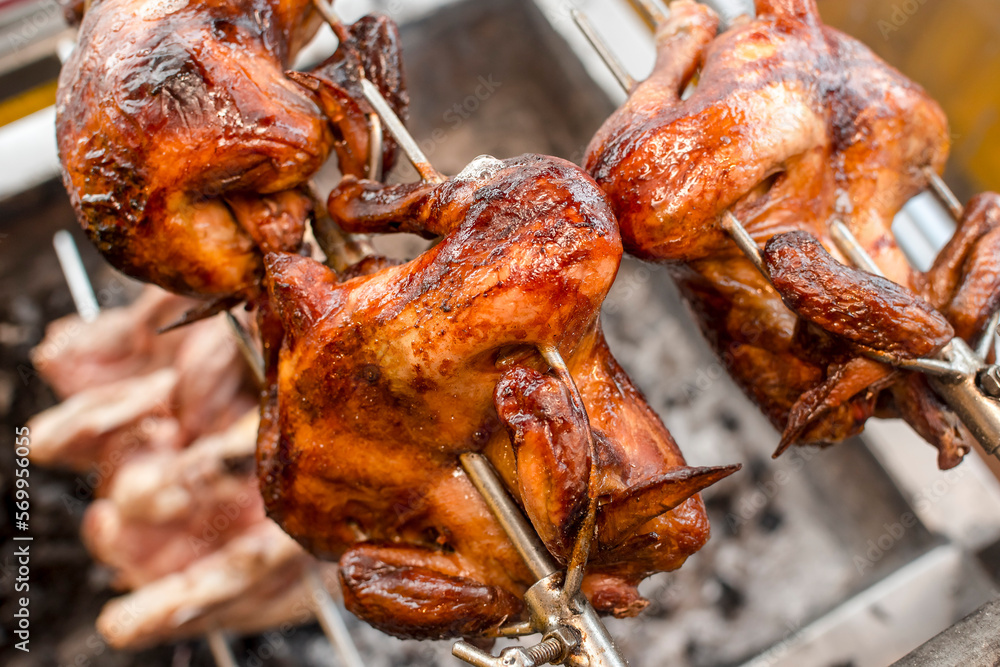 Lechon manok, a Filipino spit-roasted chicken dish. As seen being ...