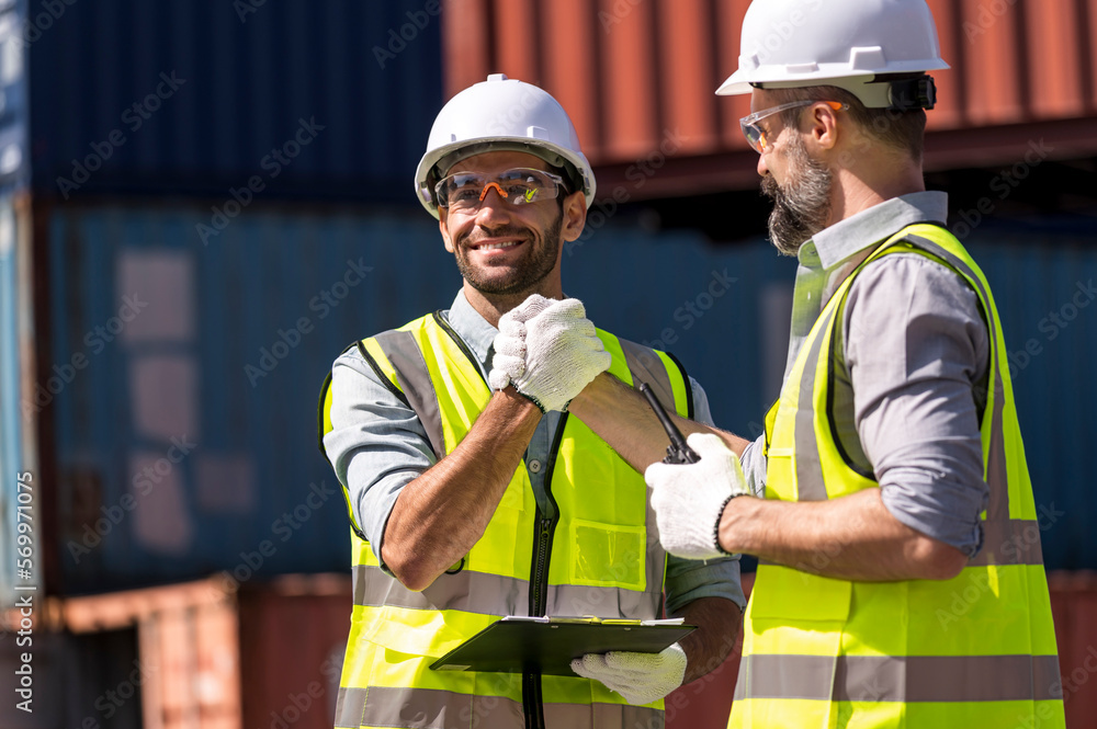 Logistics engineer and inspector holding hands with teamwork working ...