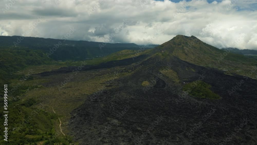 Volcano, mountains, sky with clouds, traces of lava on the ground ...