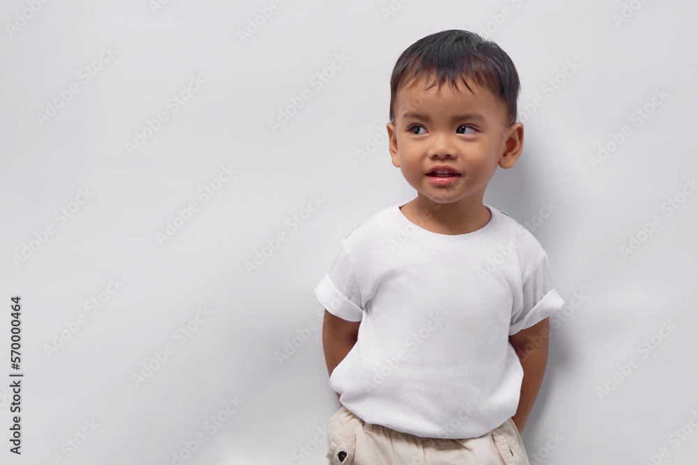 Smiling toddler Asian kid boy wearing white t-shirt standing with ...