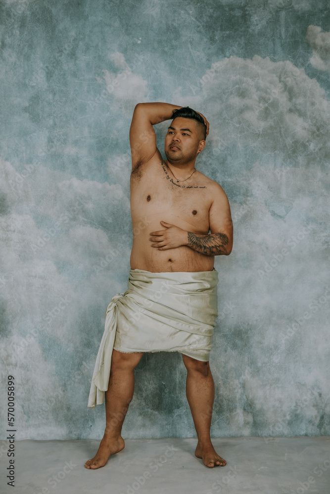 full body Filipino man wearing white fabric stretching Stock Photo ...