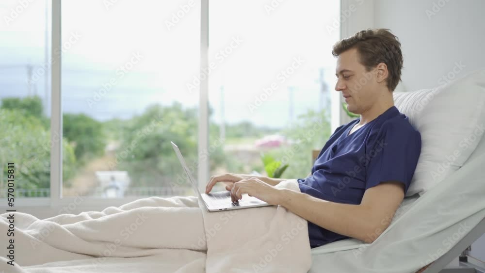 Portrait of happy caucasian sick patient using a computer notebook ...