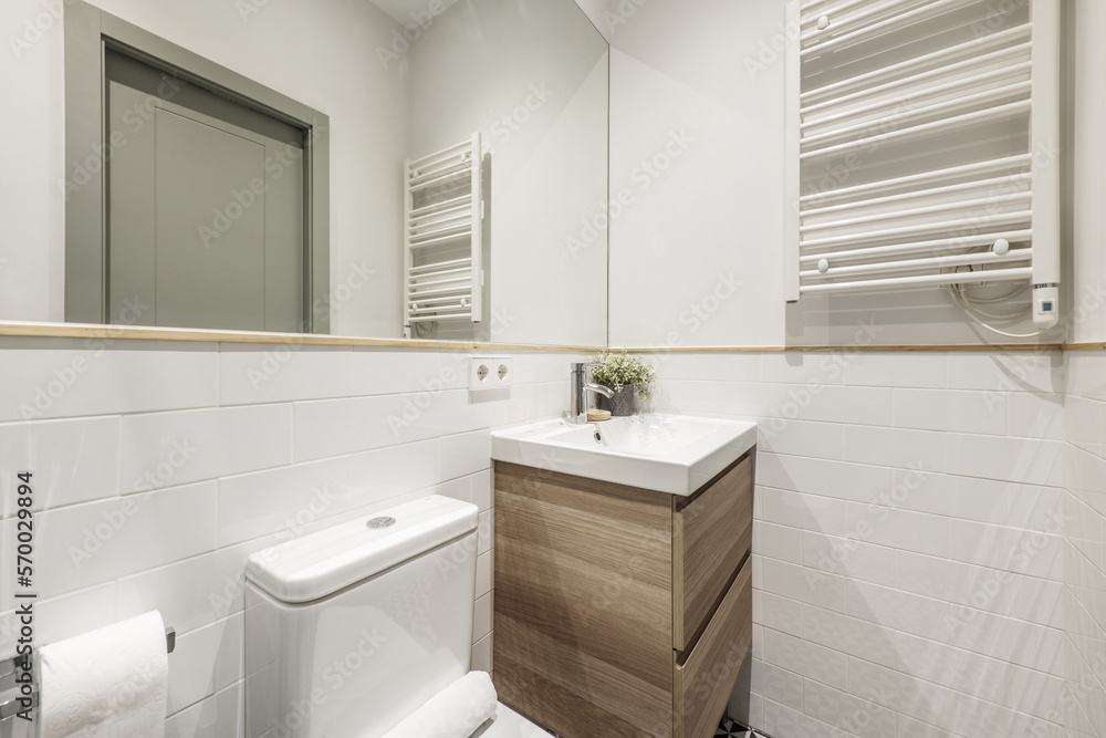 Newly renovated bathroom white porcelain sink on wooden cabinet with ...