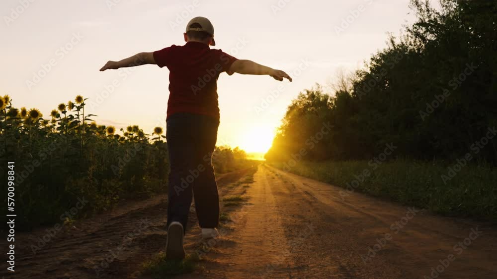 Child pilot runs through field of sunflowers, kid dreams, airplane ...