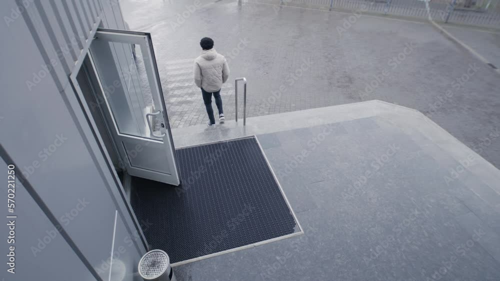 People going out and coming in entrance of modern office. Observation ...