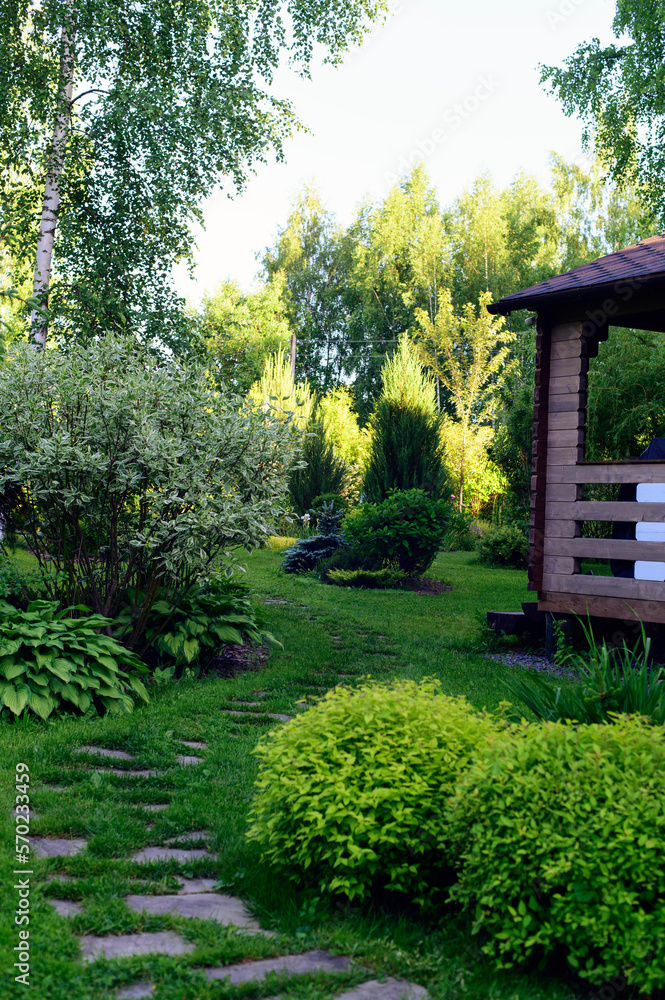 Rustic stone pathway in natural summer garden. Beautiful view with ...