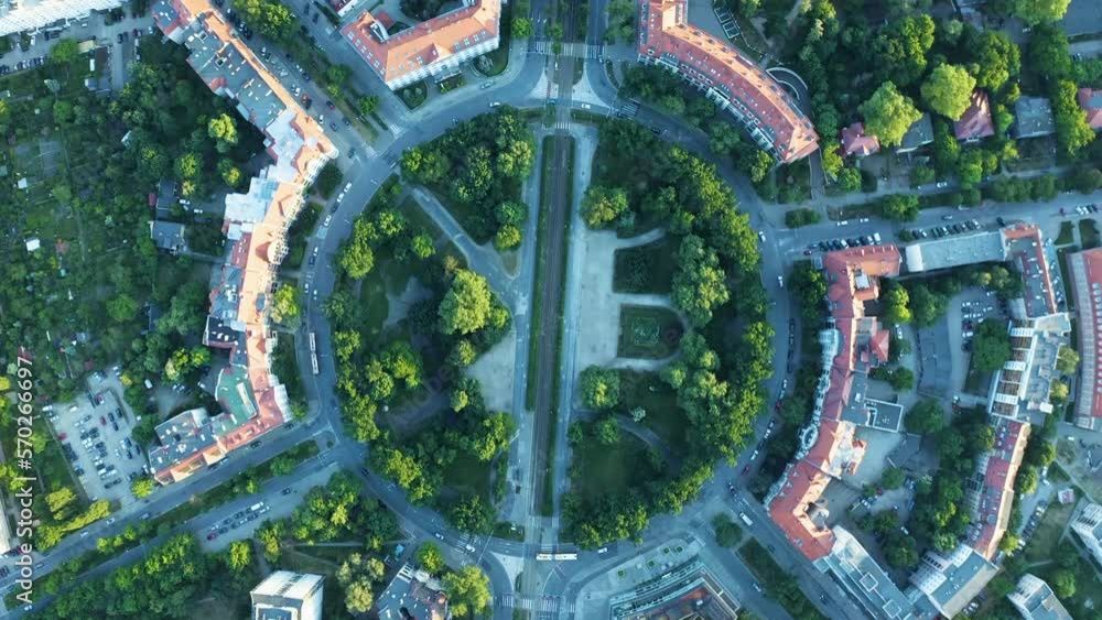 Drone video of big roundabout with moving vehicles and a lot of green ...