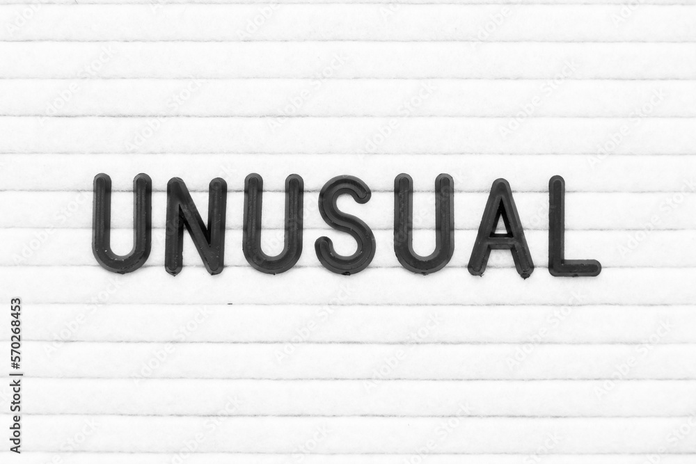 Black color letter in word unusual on white felt board background Stock ...