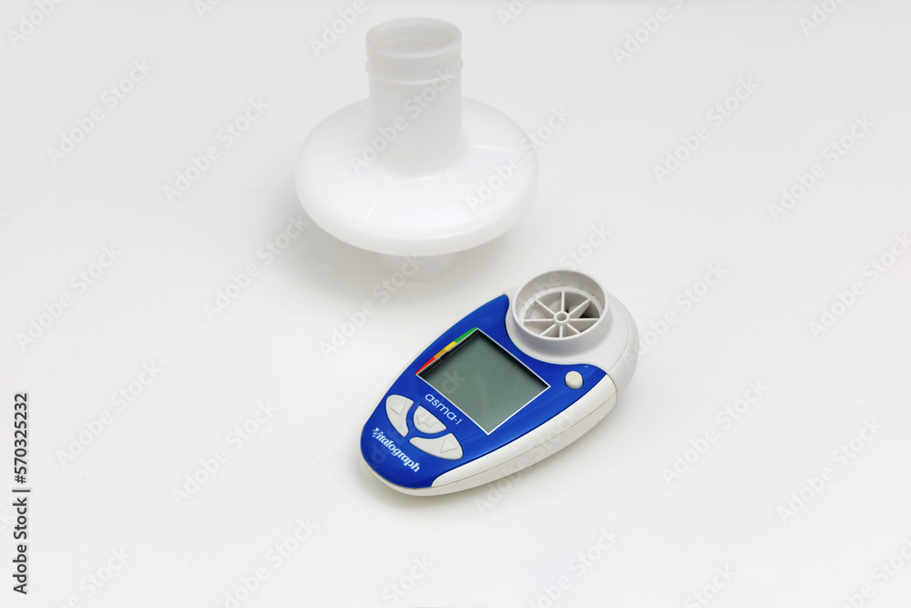 Asthma medications inhalers and peak flow meter on a white background ...