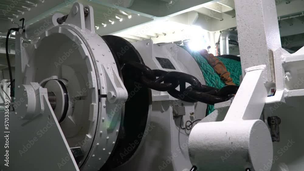 Windlass. Winch winding anchor chain. Anchor chain is wound on drum ...