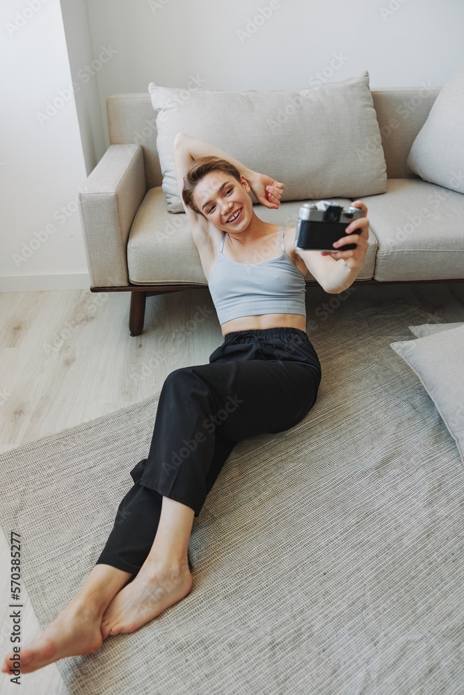 Happy smile woman holding an old camera and taking pictures of herself as a weekend photographer ...