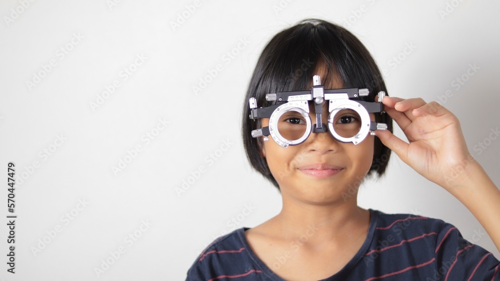 Eye exam, Elementary school girl wearing eyeglasses visual acuity test ...