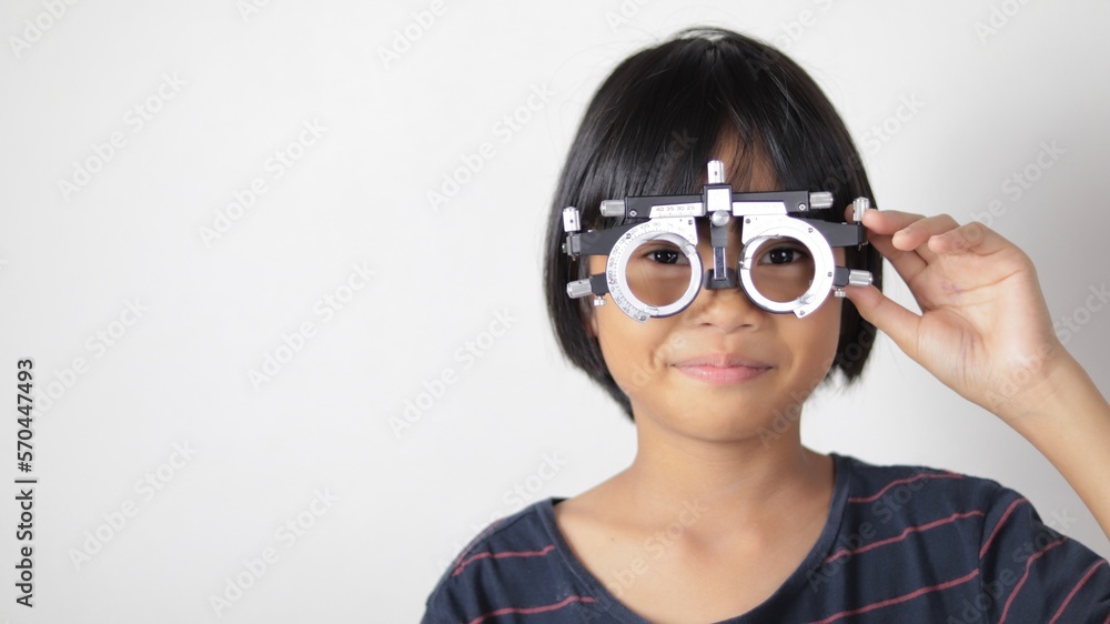 Eye exam, Elementary school girl wearing eyeglasses visual acuity test ...
