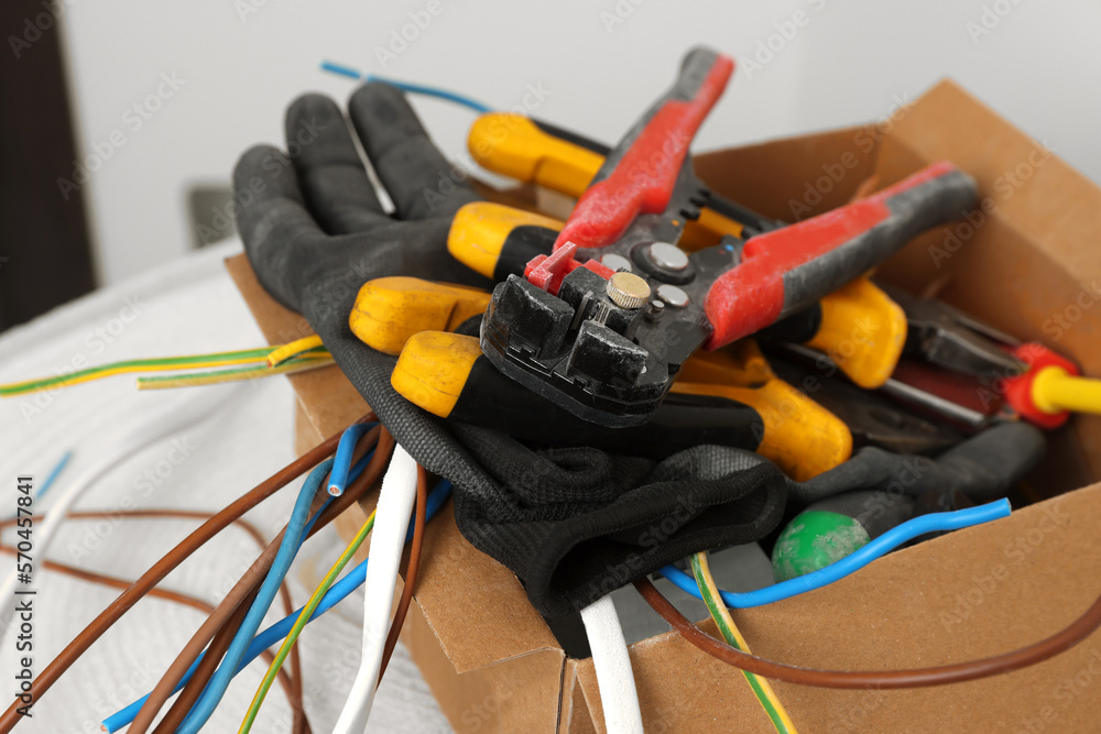 Different tools and cables in paper indoors. Installation of electrical ...