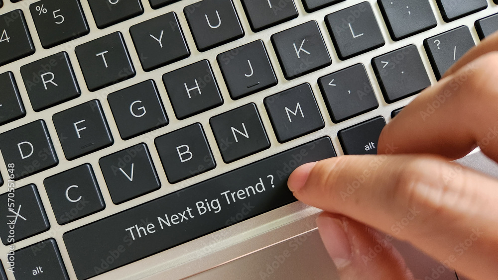 Finger pointing on a keyboard key with the wording What Is The Next Big ...