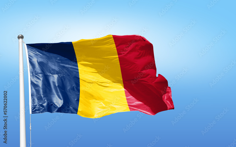 Romania flag waving in the wind on flagpole. Perspective view Romania ...