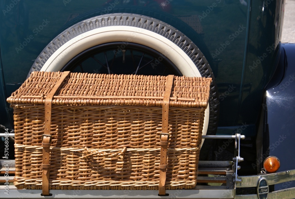 Traditional Picnic basket and spare tire on the back of a vintage ...