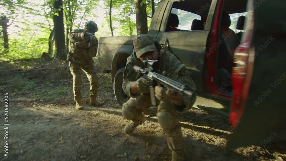 Two men in military uniform and glasses getting out of armored vehicle ...