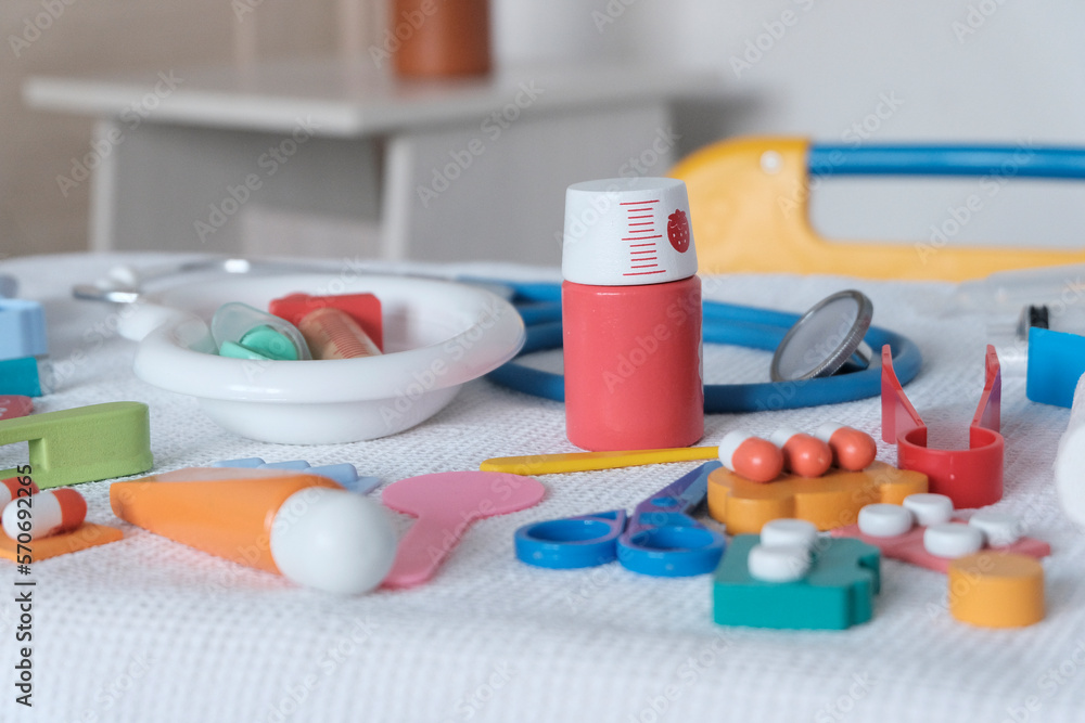 Medical toy plastic instruments on a light table. Doctor's first aid ...