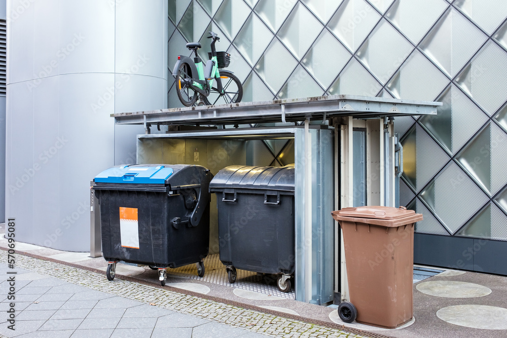 Underground garbage Bin Storage elevator lifting a parked bicycle Stock ...