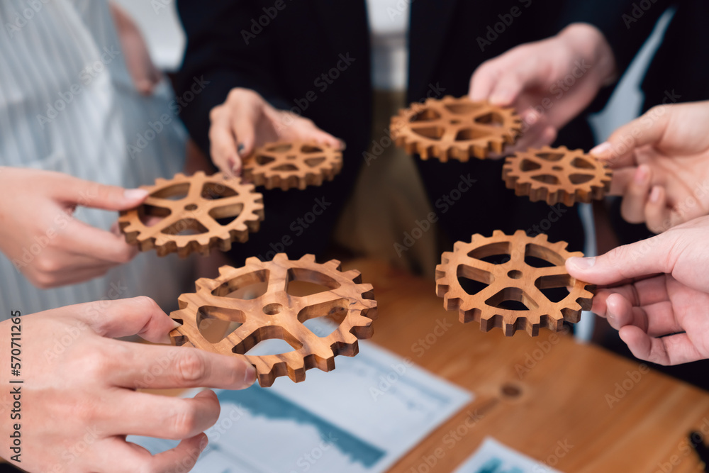 Closeup top view businesspeople hand holding gear and join together ...